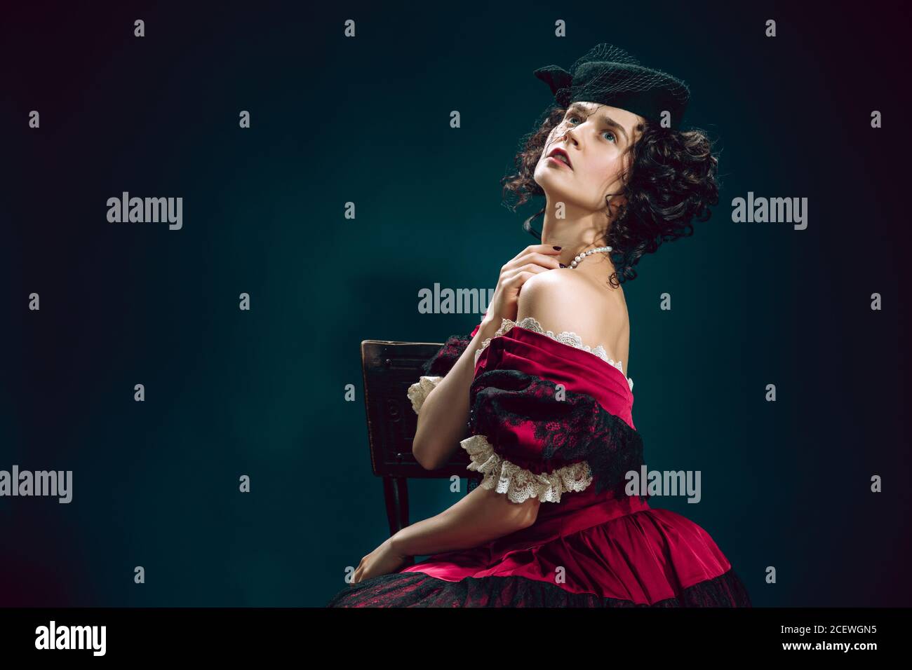 Dreamful. Young woman as Anna Karenina isolated on dark blue background ...