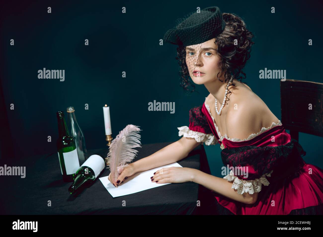 Letters writing. Young woman as Anna Karenina isolated on dark blue ...