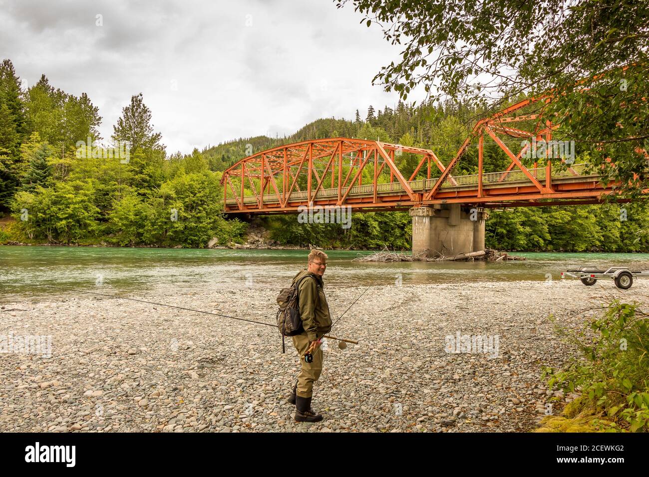 A fisherman at the upper Red Highway Bridge on the Kitimat River ...