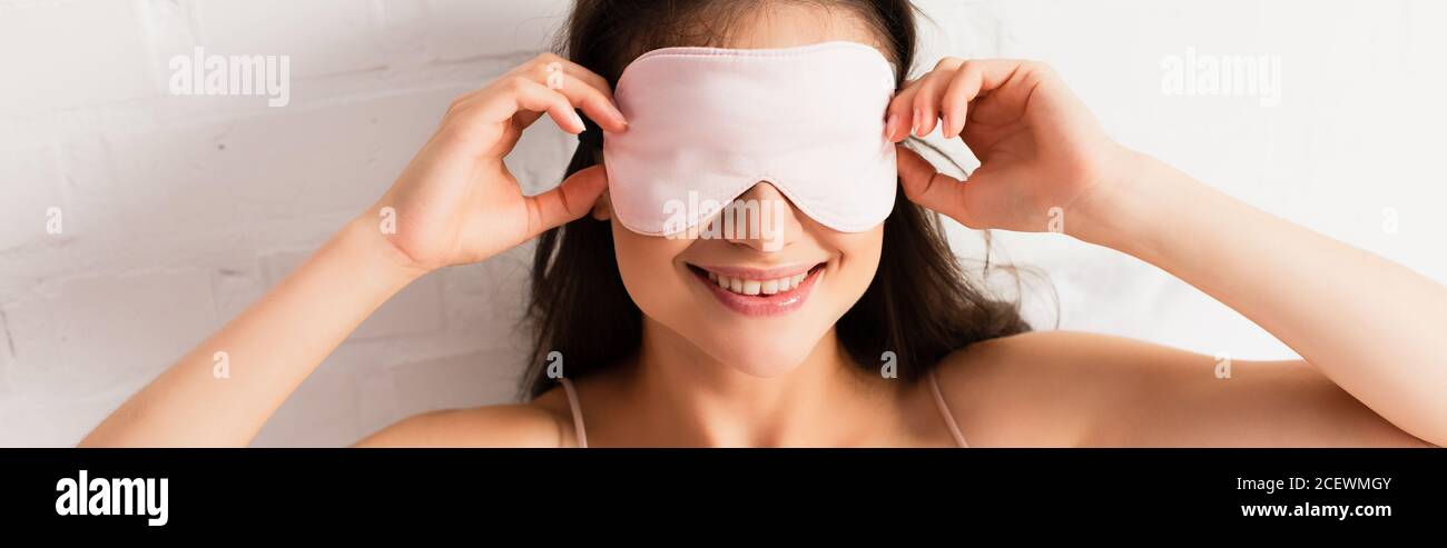 horizontal image of woman touching pink eye mask Stock Photo - Alamy