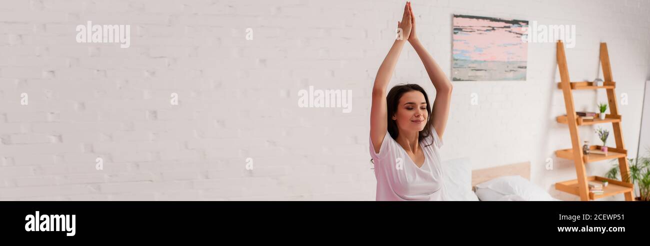 website header of woman with praying hands above head Stock Photo - Alamy