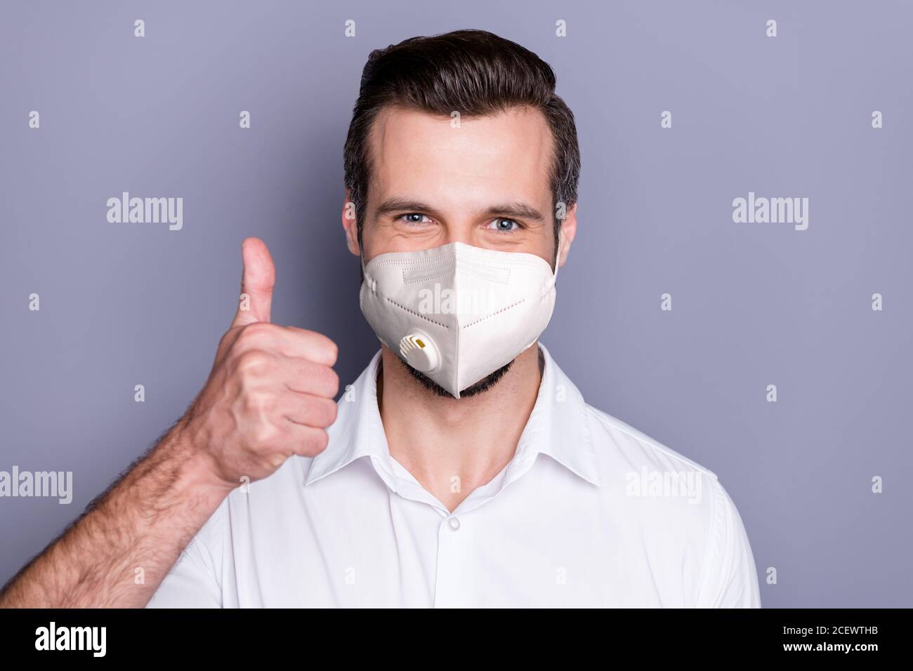 Close-up portrait of his he attractive healthy guy wearing safety n95 ...
