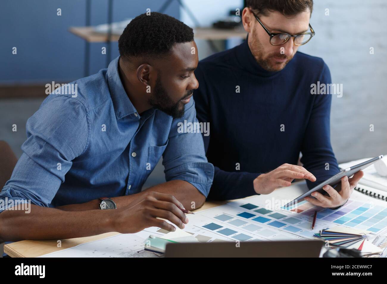 Multiracial engineer team working in office with tablet PC. Architects ...