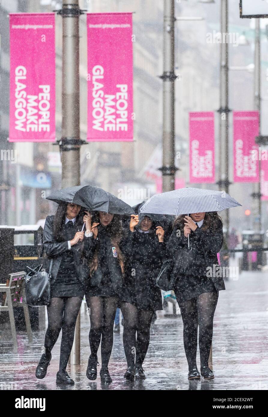 School pupils caught in heavy rain in Glasgow city centre Stock Photo ...