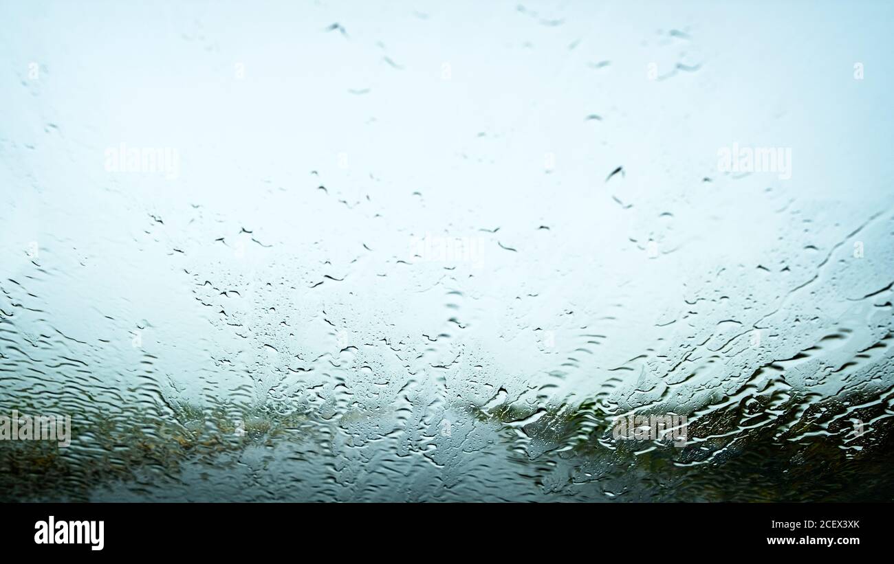 View through the car window in the rain. Rainy weather through the car ...