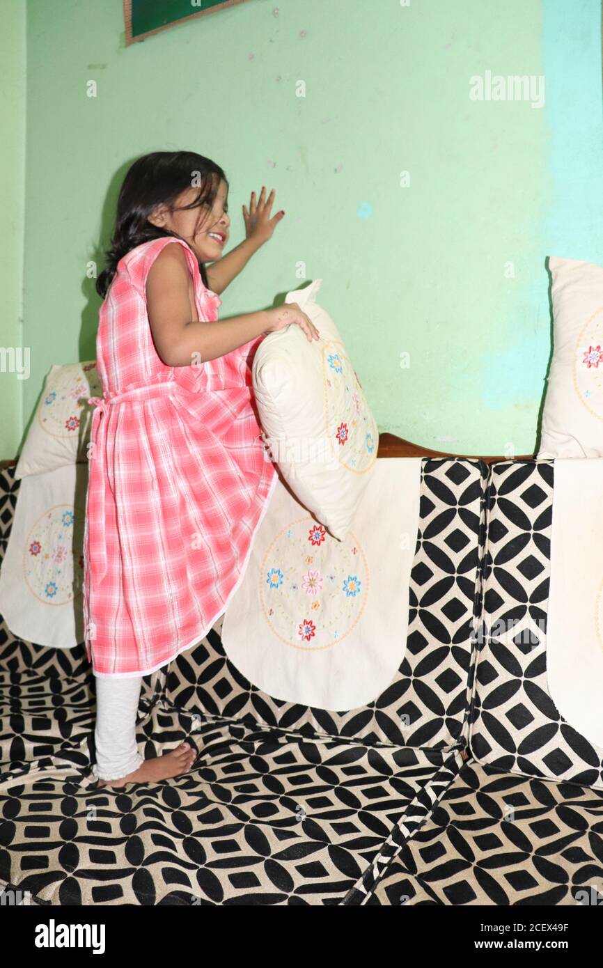 Little kid playing alone in the drawing room Stock Photo - Alamy