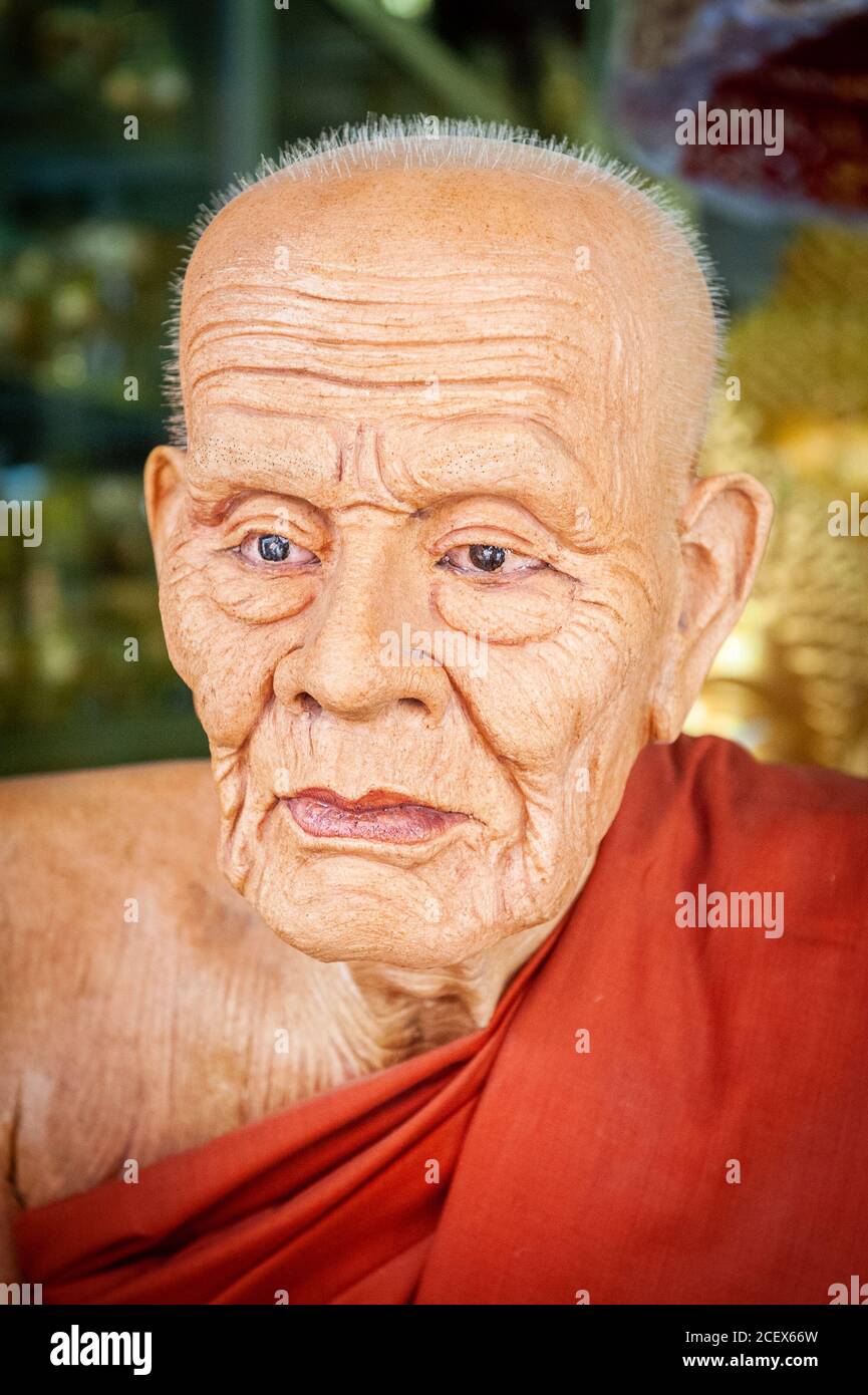 Incredibly life like mini wax models of Thai monks sit in a shop in ...