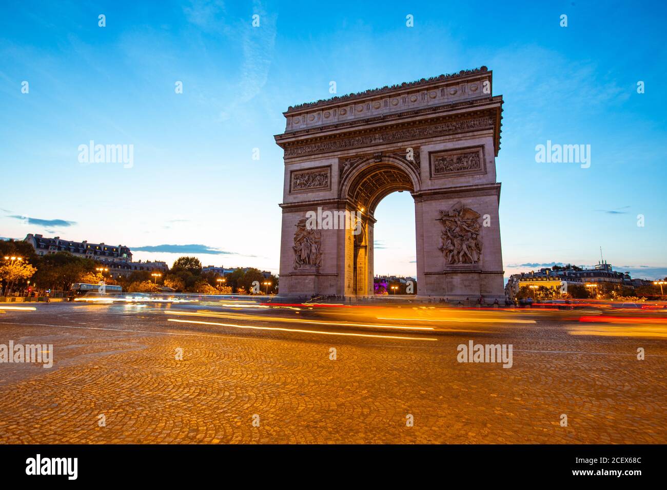 Sunset view of Arc de Triomphe and the traffic in Paris, France Stock ...