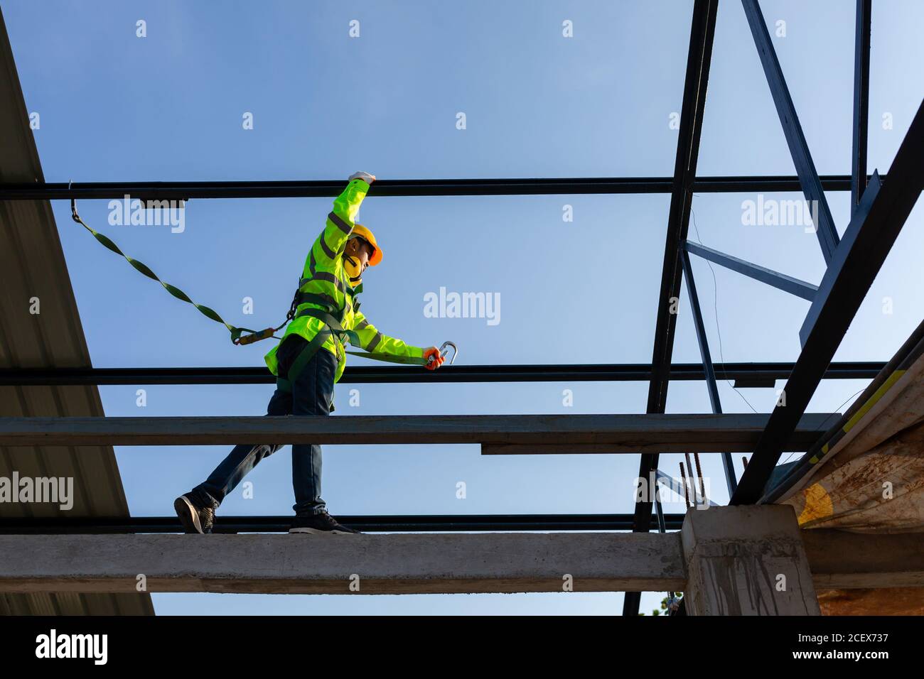Asian worker wear safety height equipment to install the roof in the ...