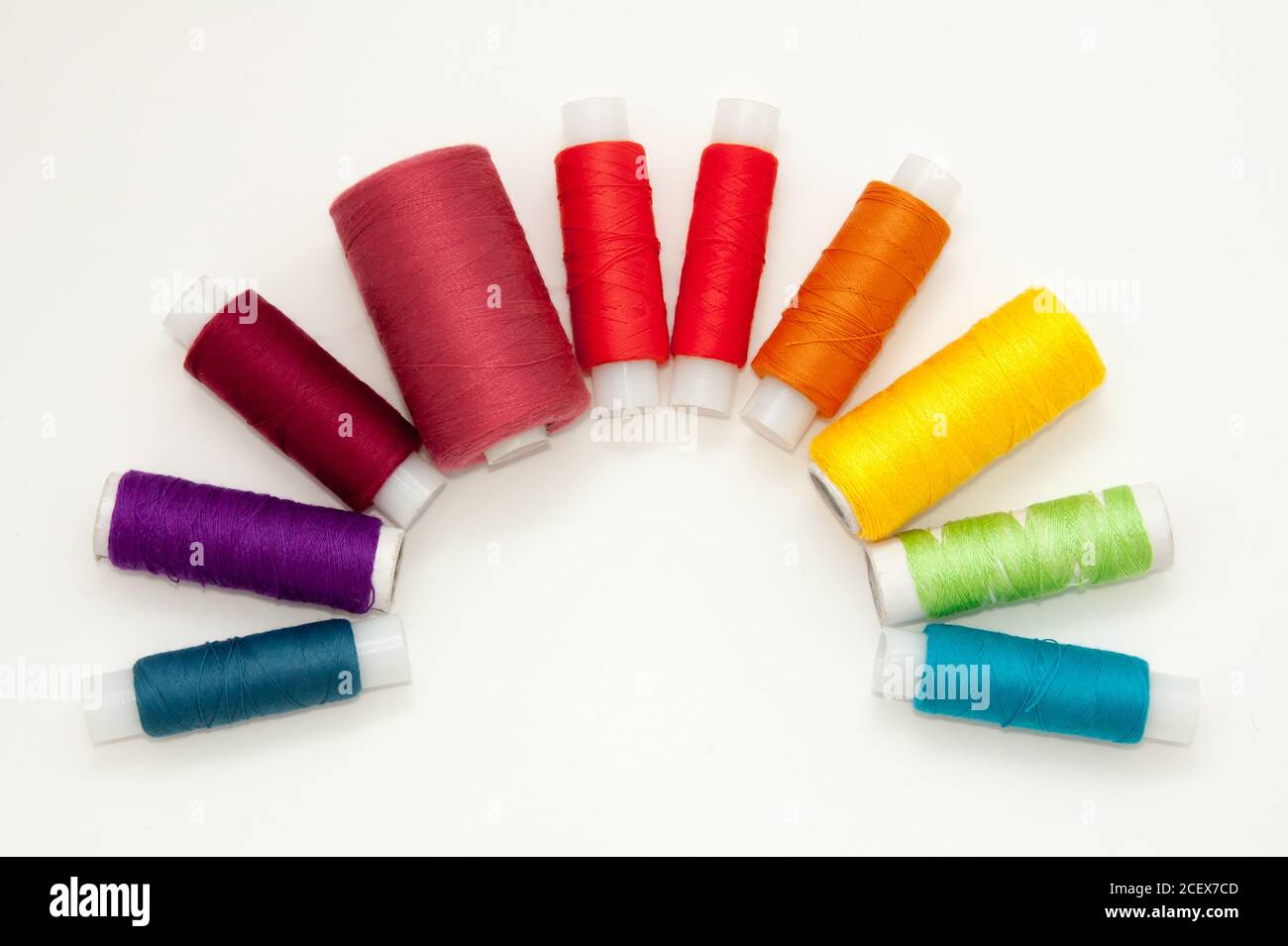 Flat lay with colorful cotton thread spools, embroidery yarn, rainbow ...