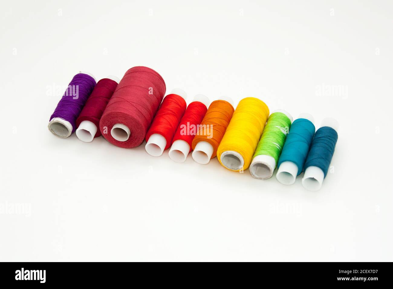 Flat lay with colorful cotton thread spools, embroidery yarn, rainbow ...