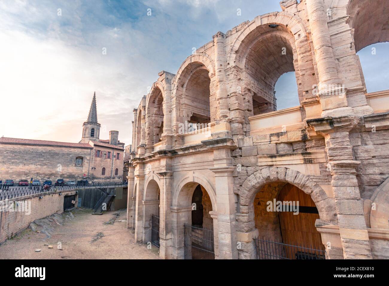 The street view of the roman ruins in Arles, Provence, at sunset Stock ...