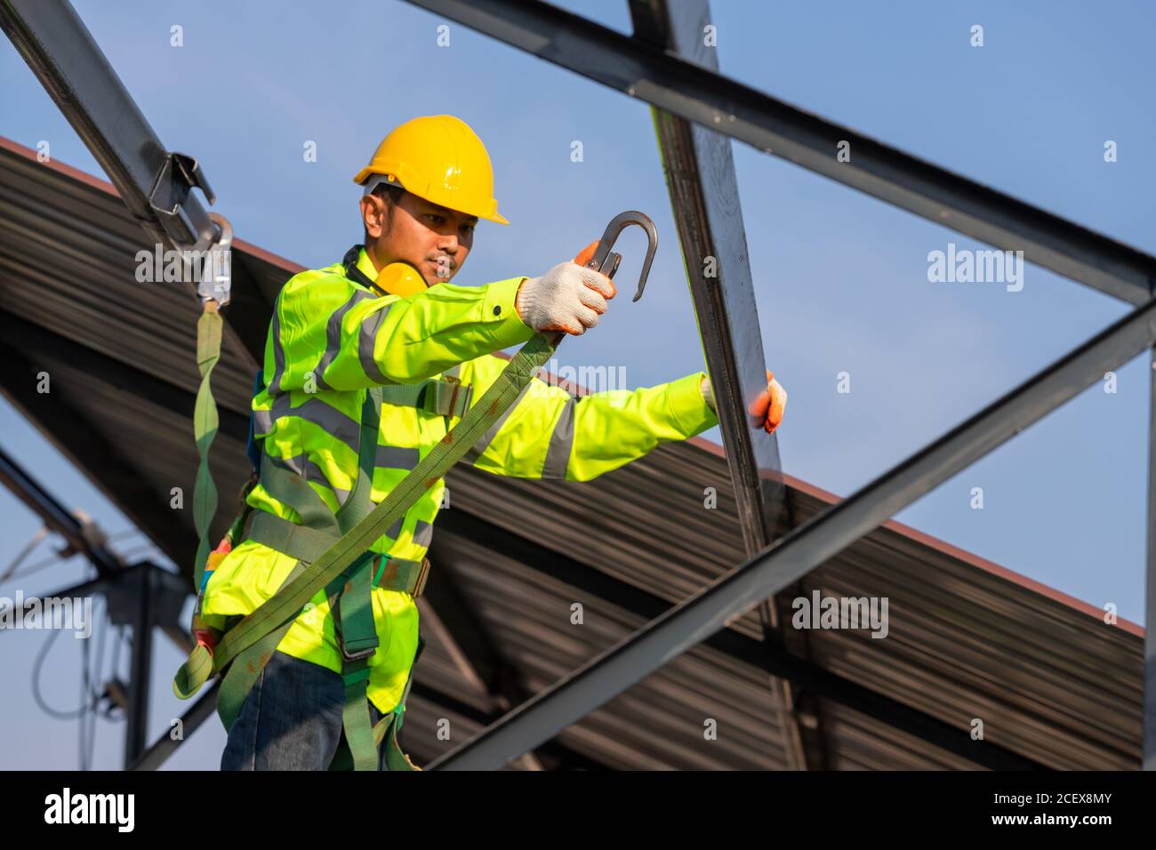 Asian roof construction worker wear safety height equipment to install ...