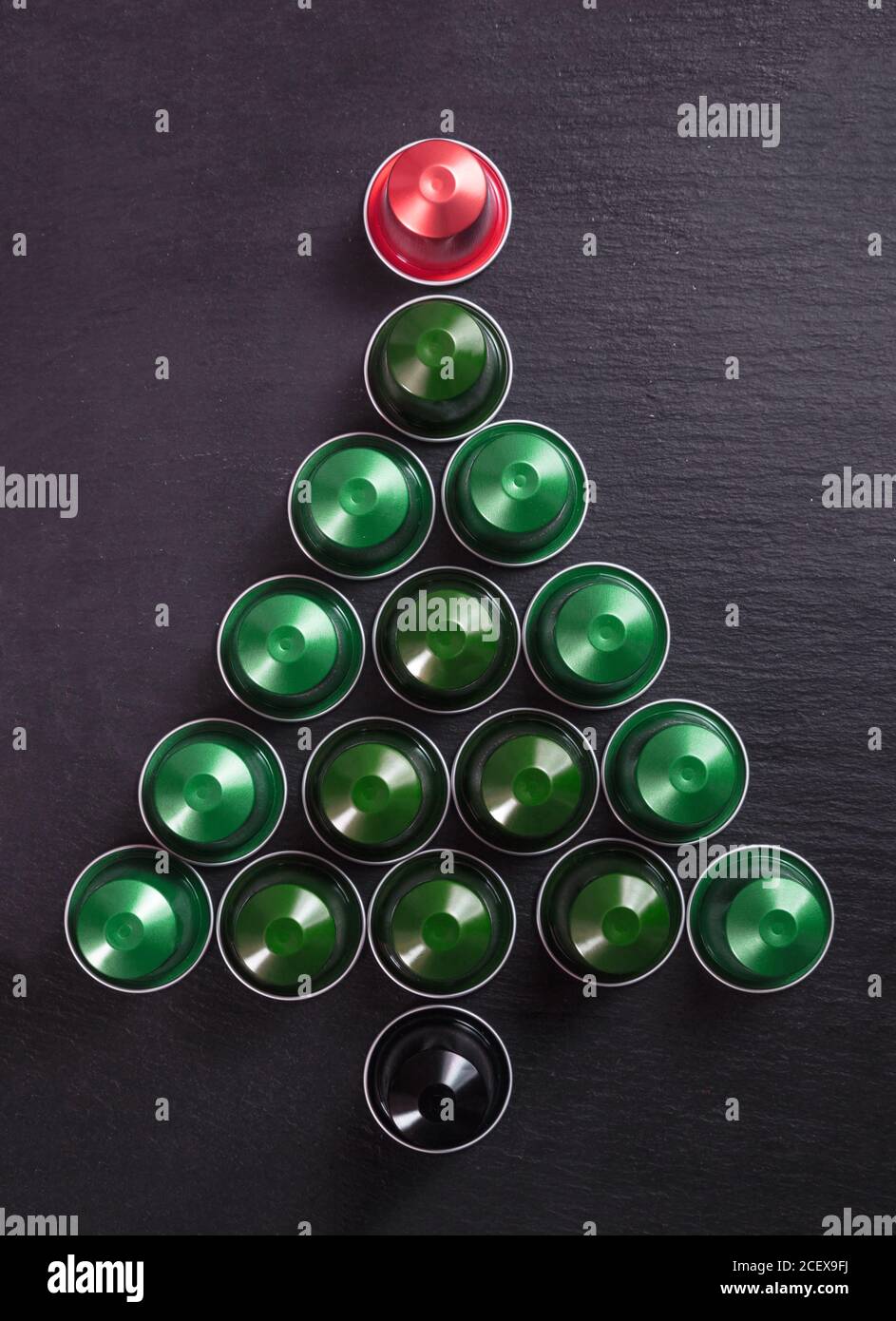 Espresso coffee capsules christmas tree shape on black background, top ...
