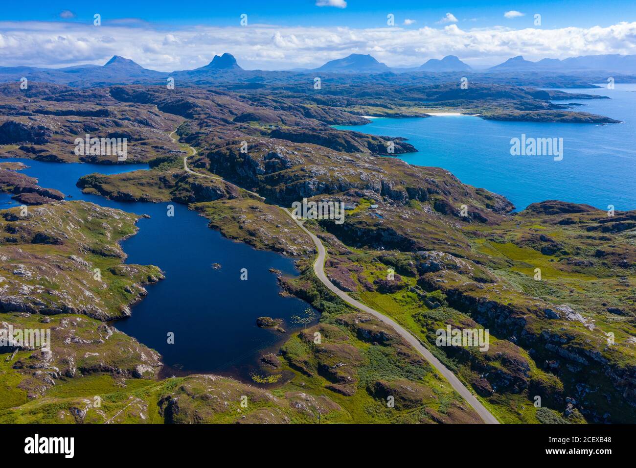 Aerial view of mountains and single track road part of North Coast 500 ...