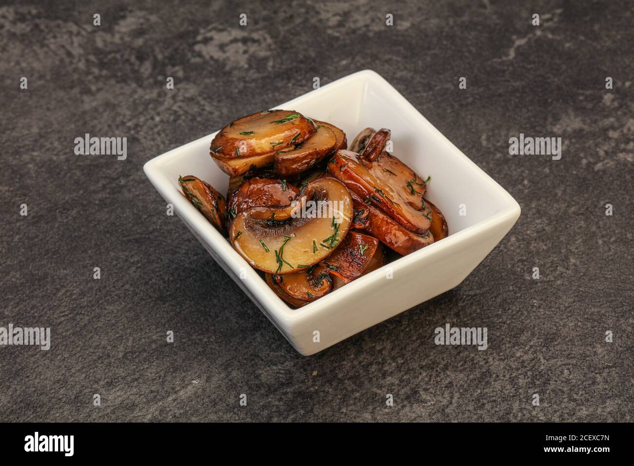 Roasted champignon with herbs and spices in the bowl Stock Photo - Alamy