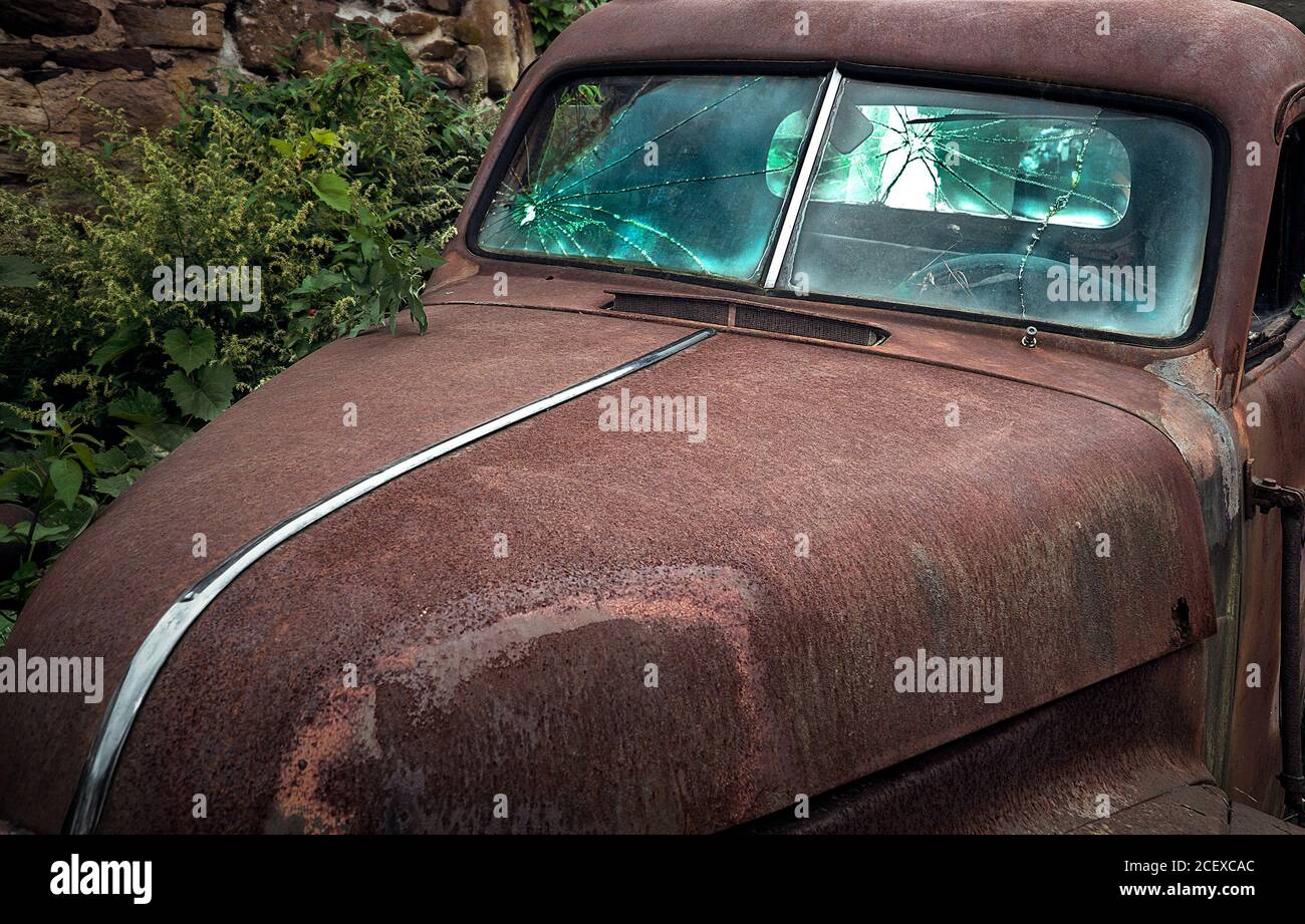Abandoned wrecked and rusty car with broken windshield Stock Photo - Alamy