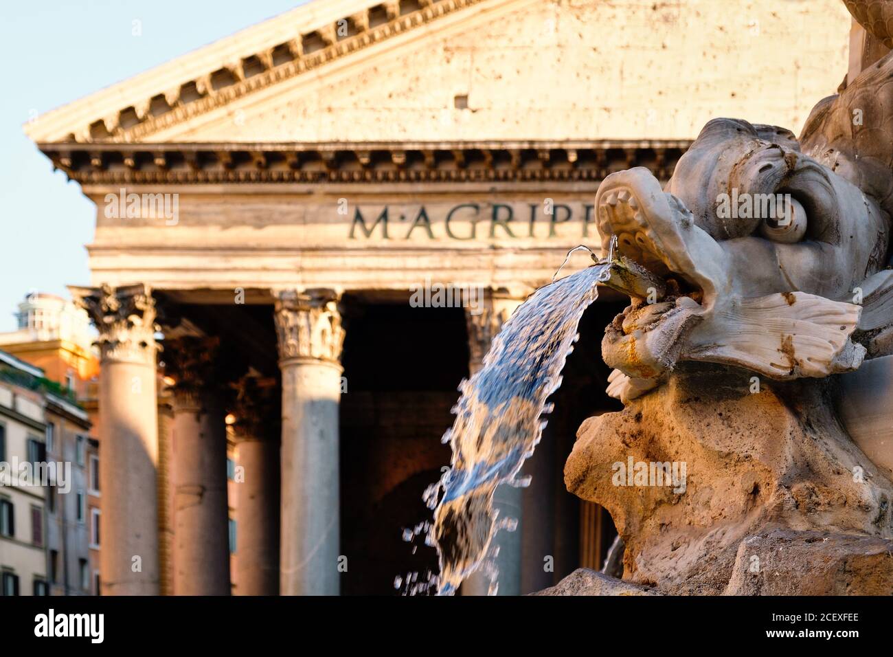 Fountain and the ancient roman Pantheon in Rome illuminated at sunset ...