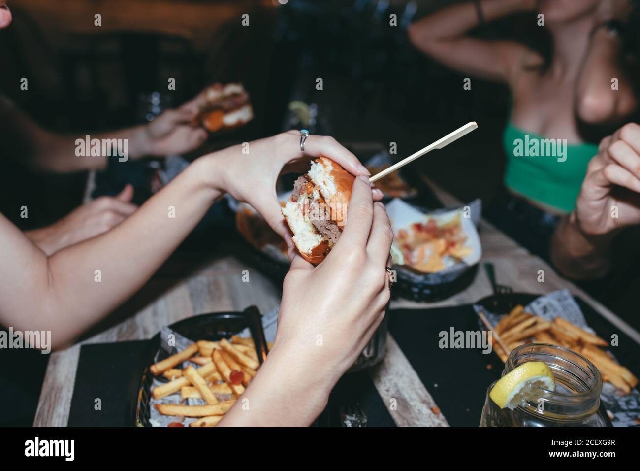 Cheerful friends having fun in fast food cafe Stock Photo - Alamy