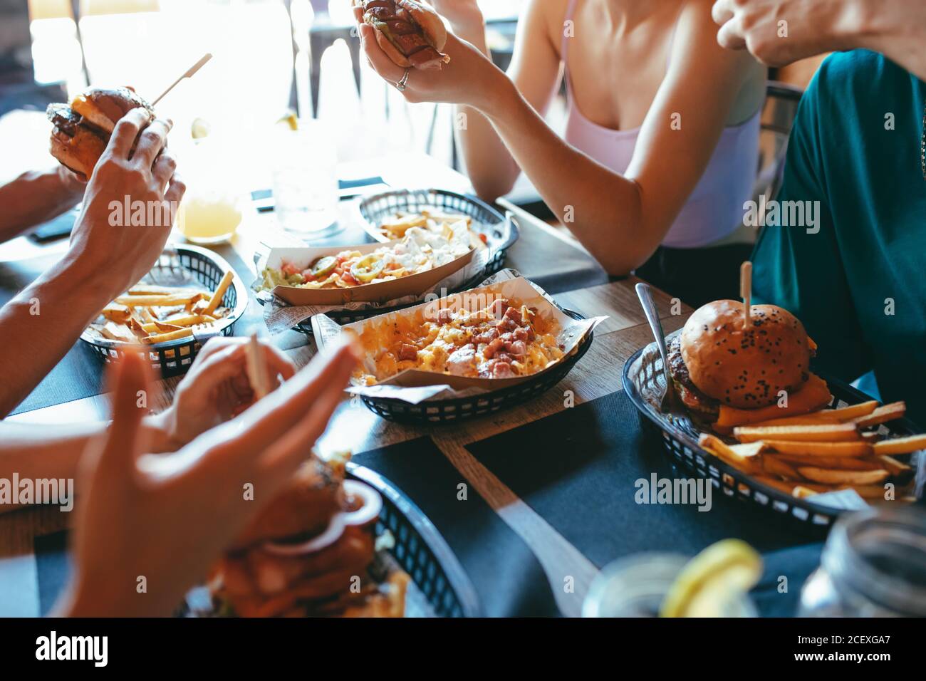 Cheerful friends having fun in fast food cafe Stock Photo - Alamy