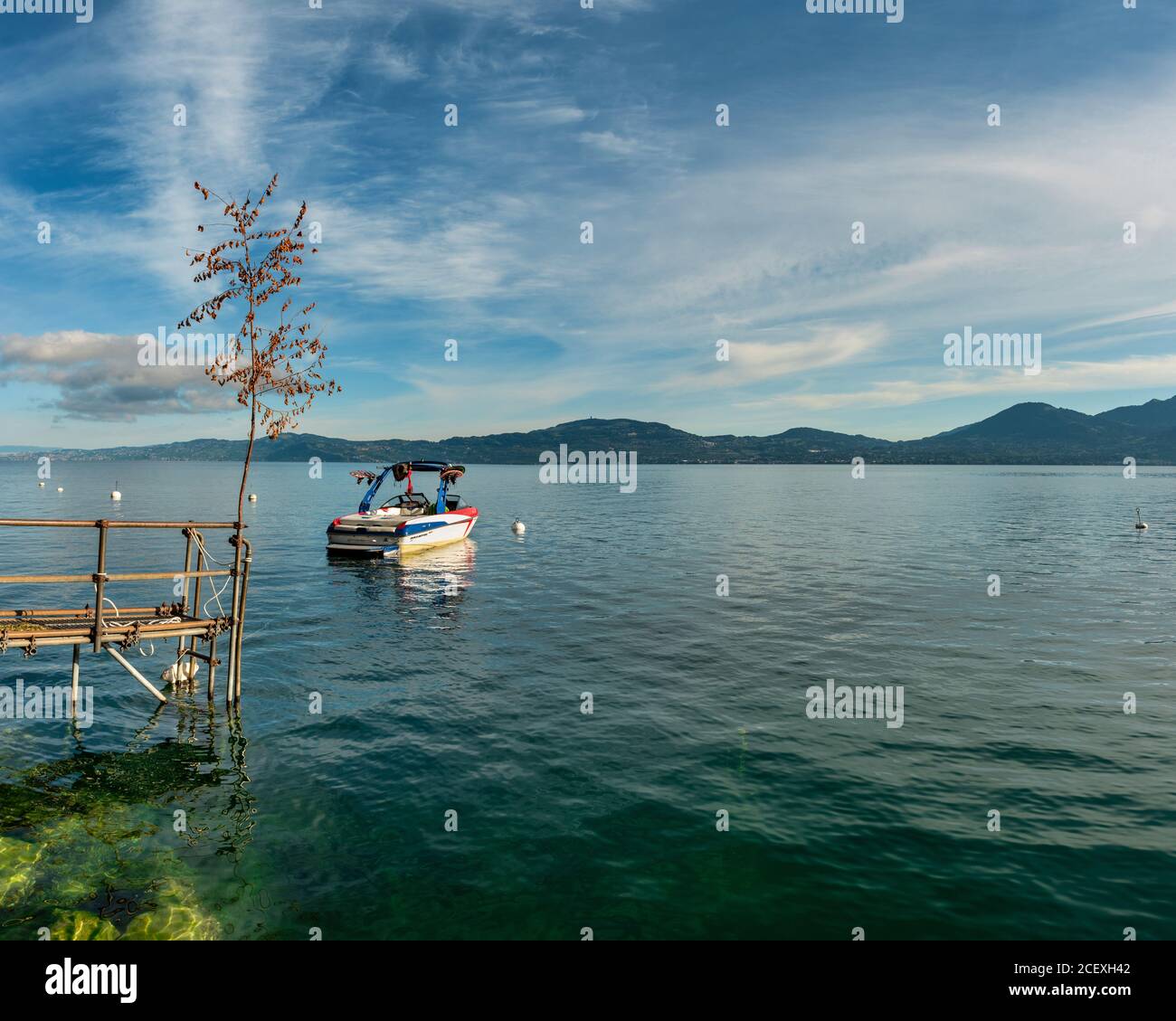 A boat on the crystal clear lake Geneva, Switzerland Stock Photo - Alamy