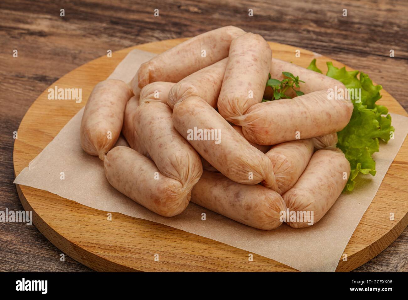 Raw natural chicken baby sausages for roast Stock Photo - Alamy
