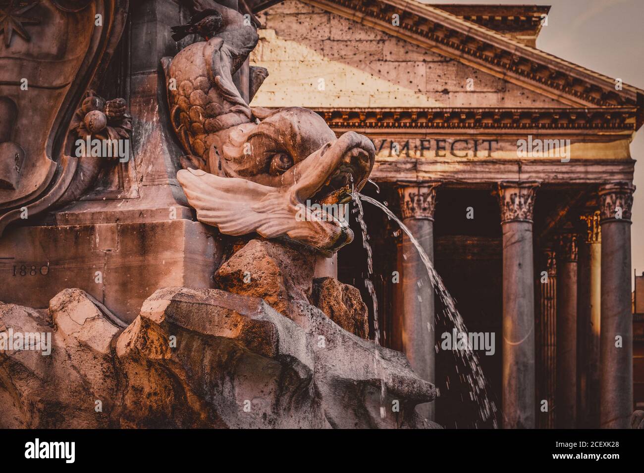 Fountain and the ancient roman Pantheon in Rome illuminated at sunset ...