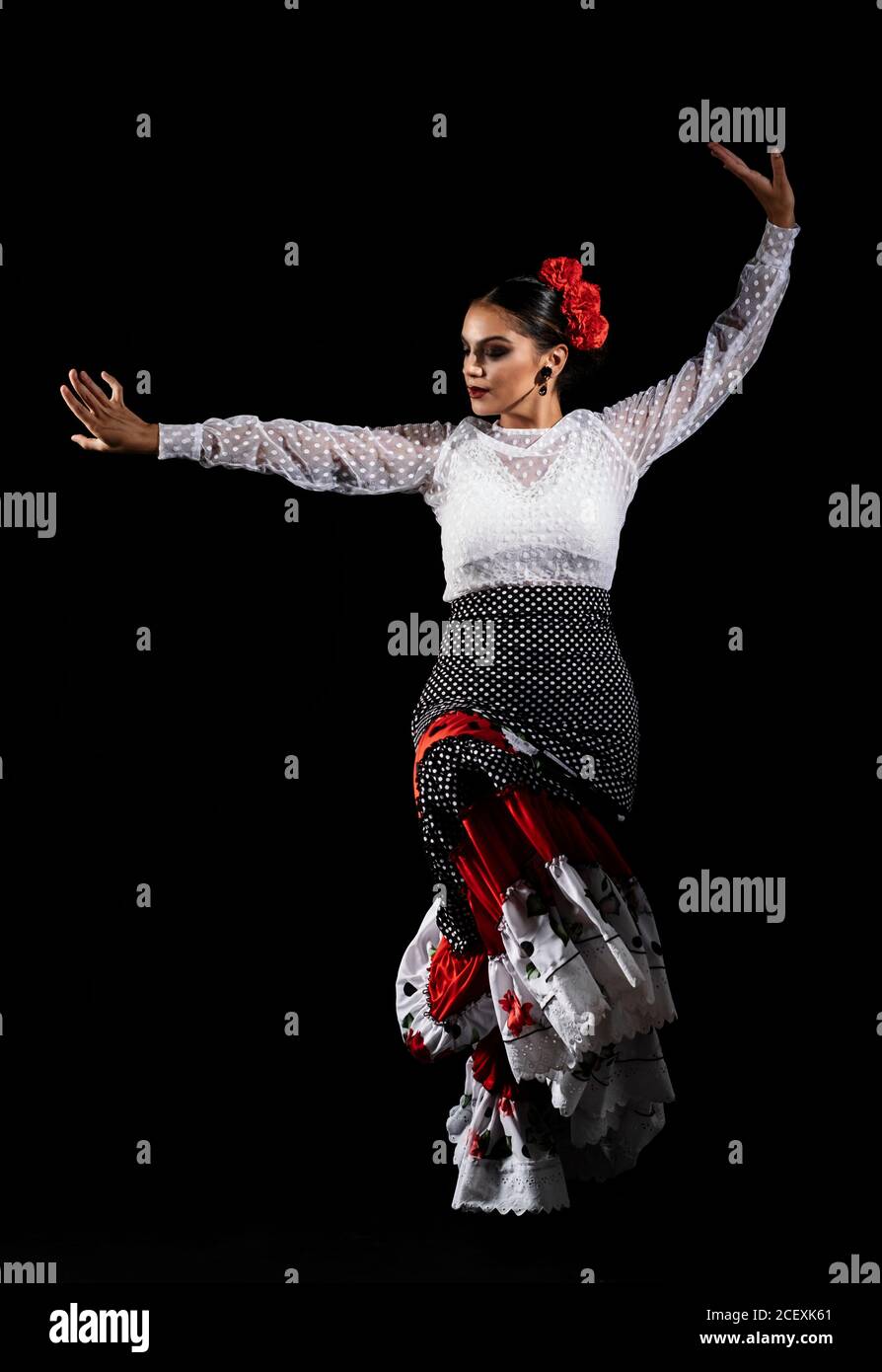 Full body elegant young Hispanic Woman in traditional outfit dancing ...