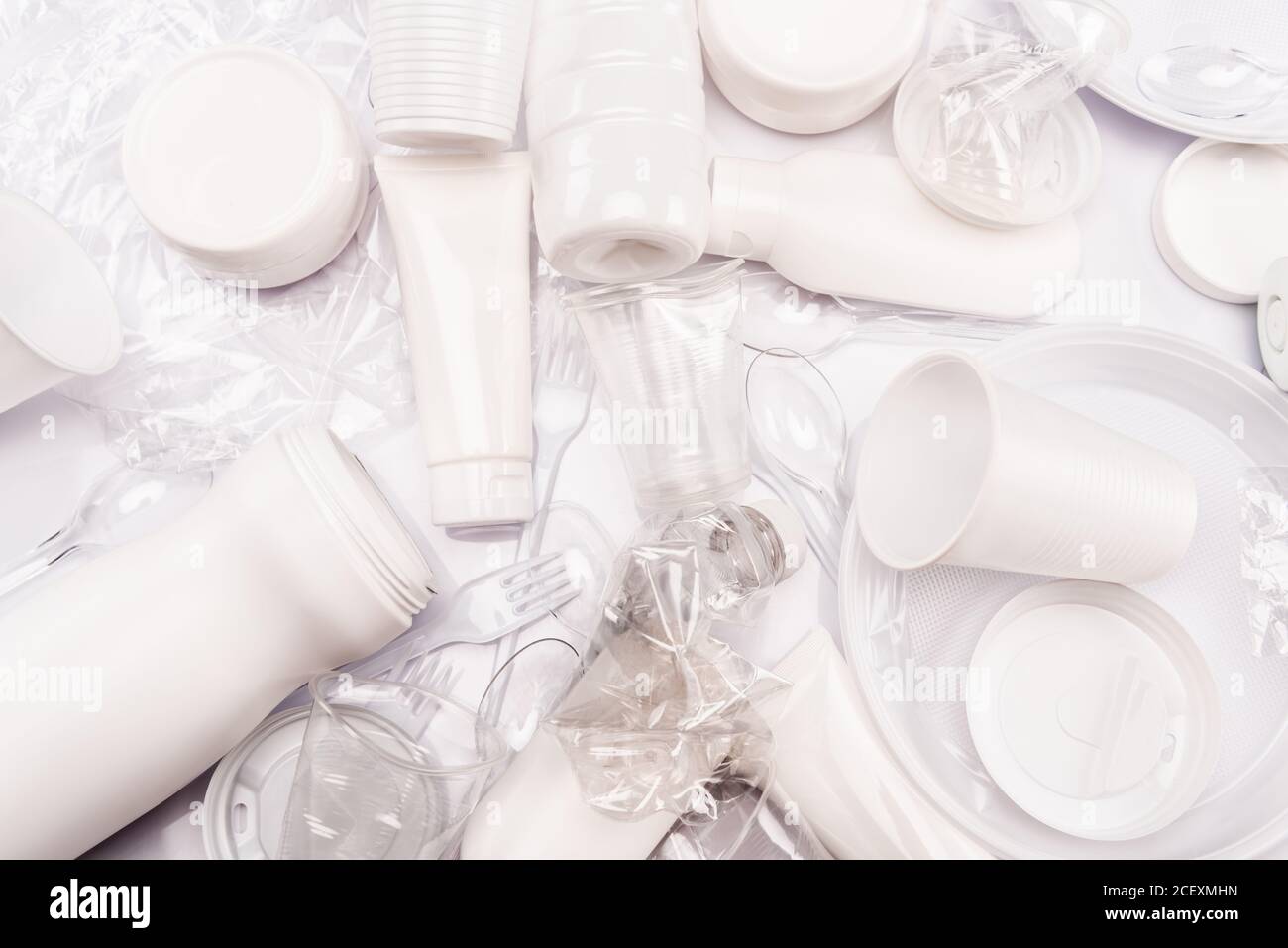 top view plastic rubbish scattered on white background Stock Photo - Alamy