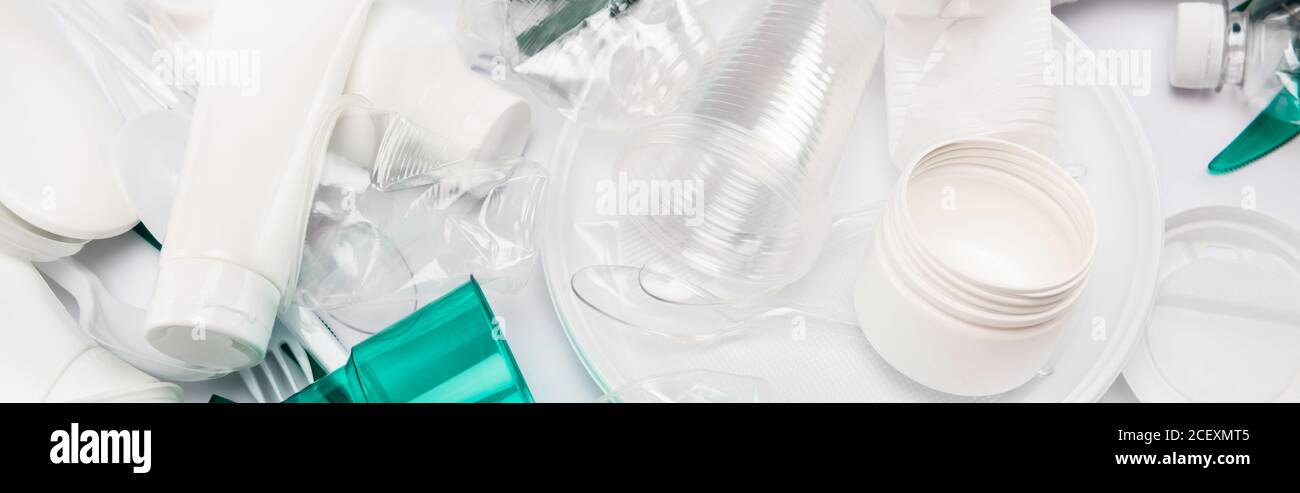 top view of plastic rubbish scattered on white background, panoramic ...