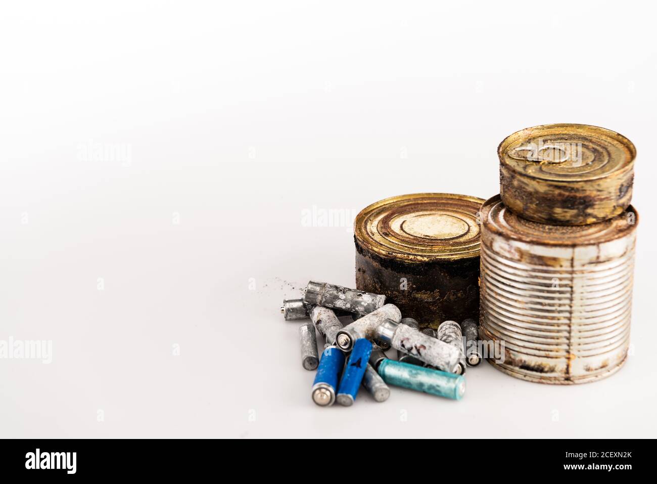 metal rusty tins and used batteries on white background Stock Photo - Alamy