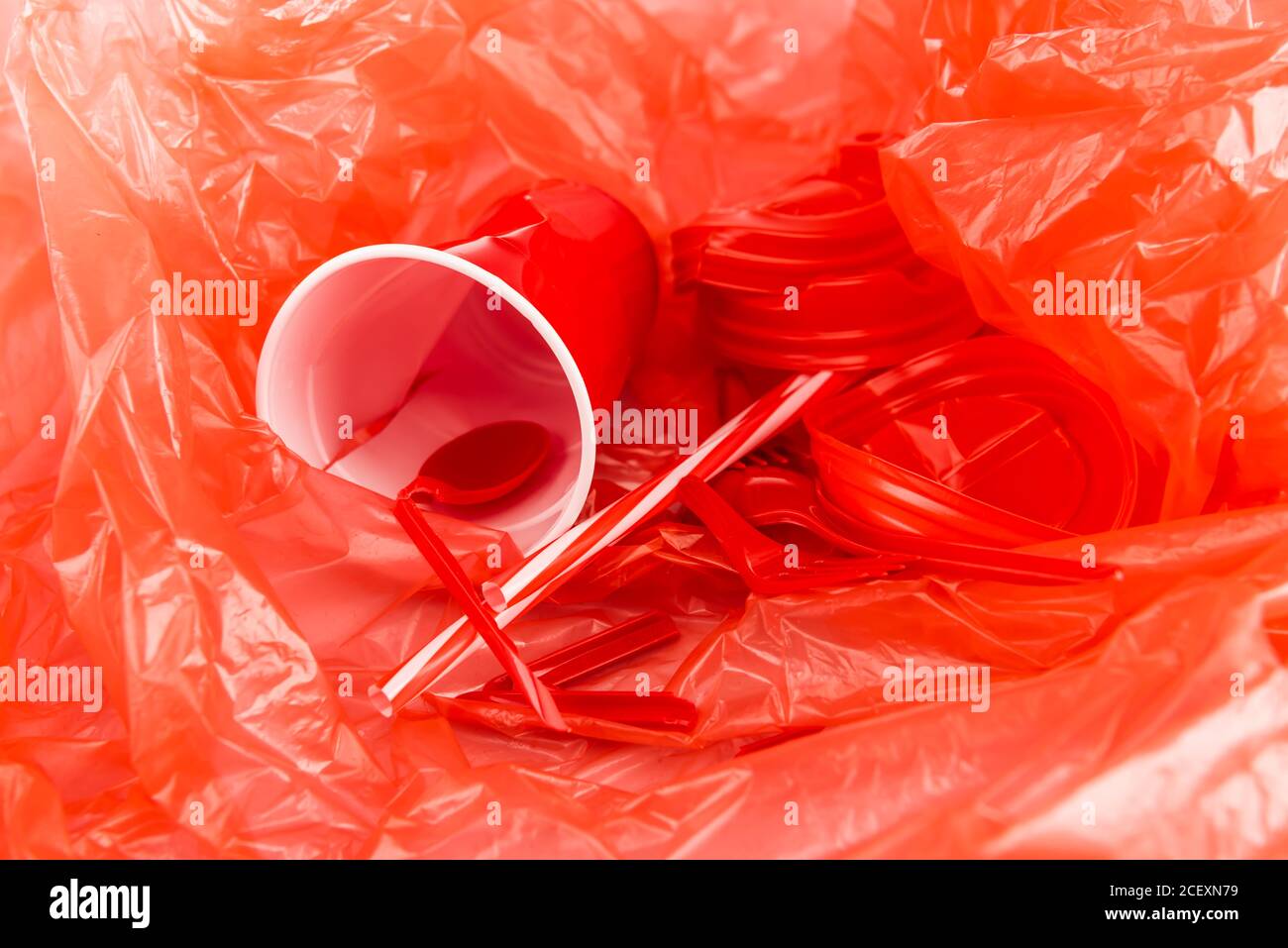 red disposable objects on plastic crumpled texture Stock Photo - Alamy