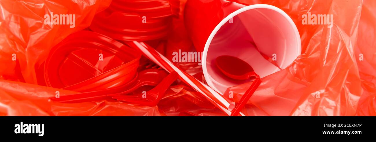 red disposable objects on plastic crumpled texture, panoramic shot ...