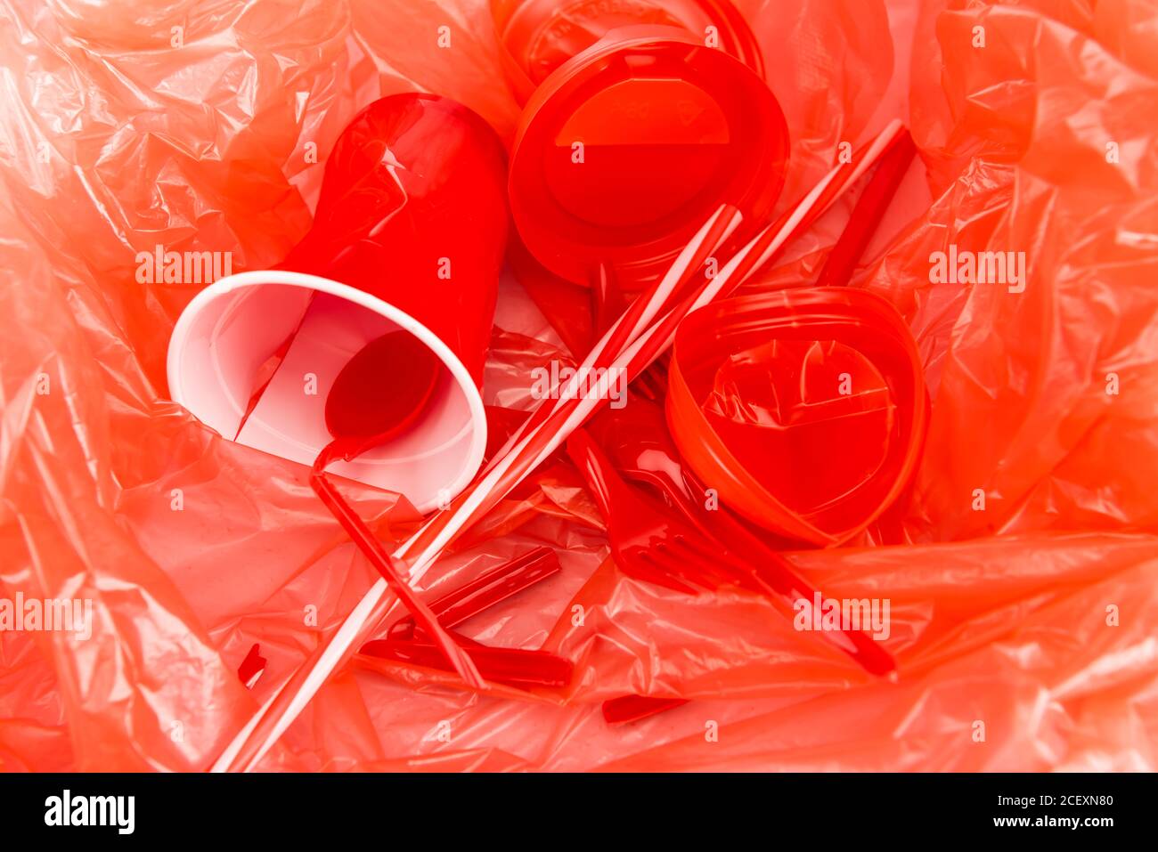red disposable objects on plastic crumpled texture Stock Photo - Alamy