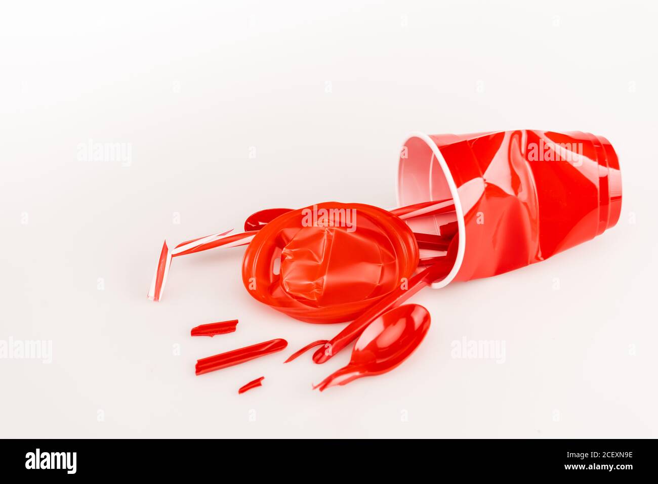broken red plastic objects on white background Stock Photo - Alamy