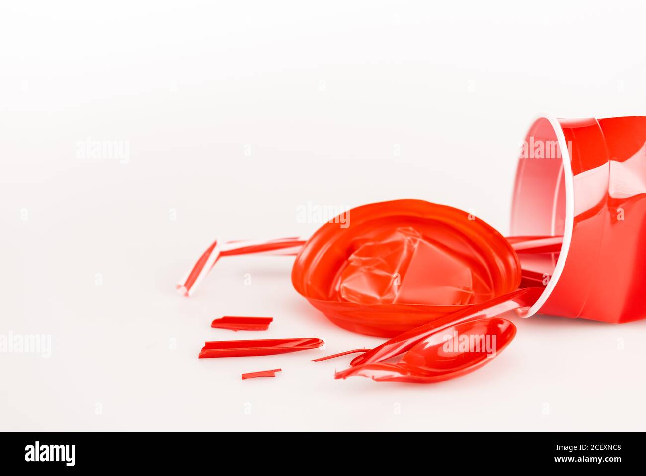 broken red plastic objects on white background Stock Photo - Alamy