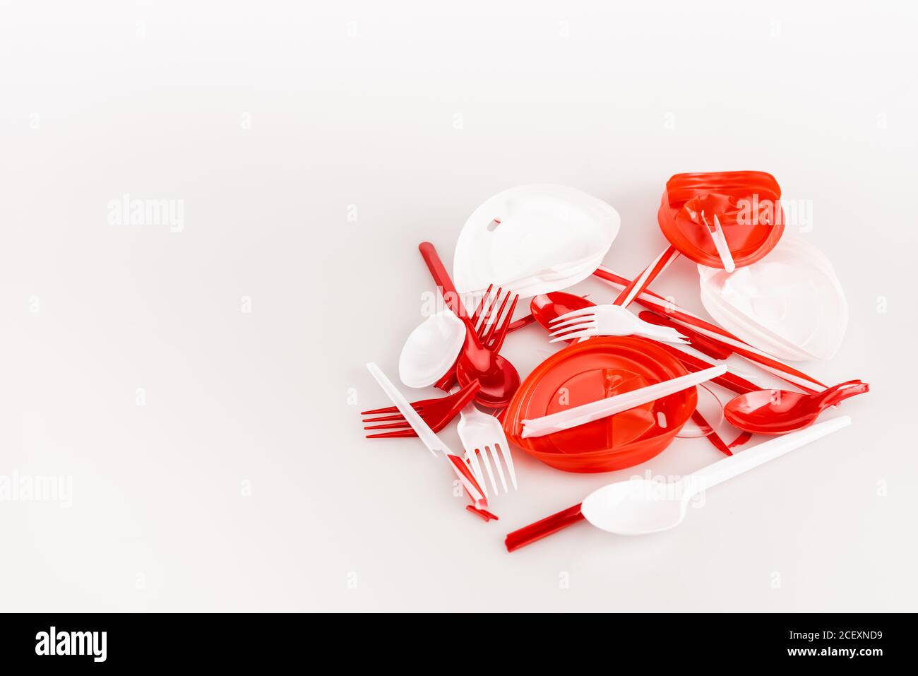 red plastic trash scattered on white background Stock Photo - Alamy
