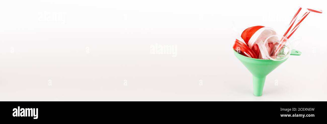 red plastic objects in funnel on white background, panoramic shot Stock ...