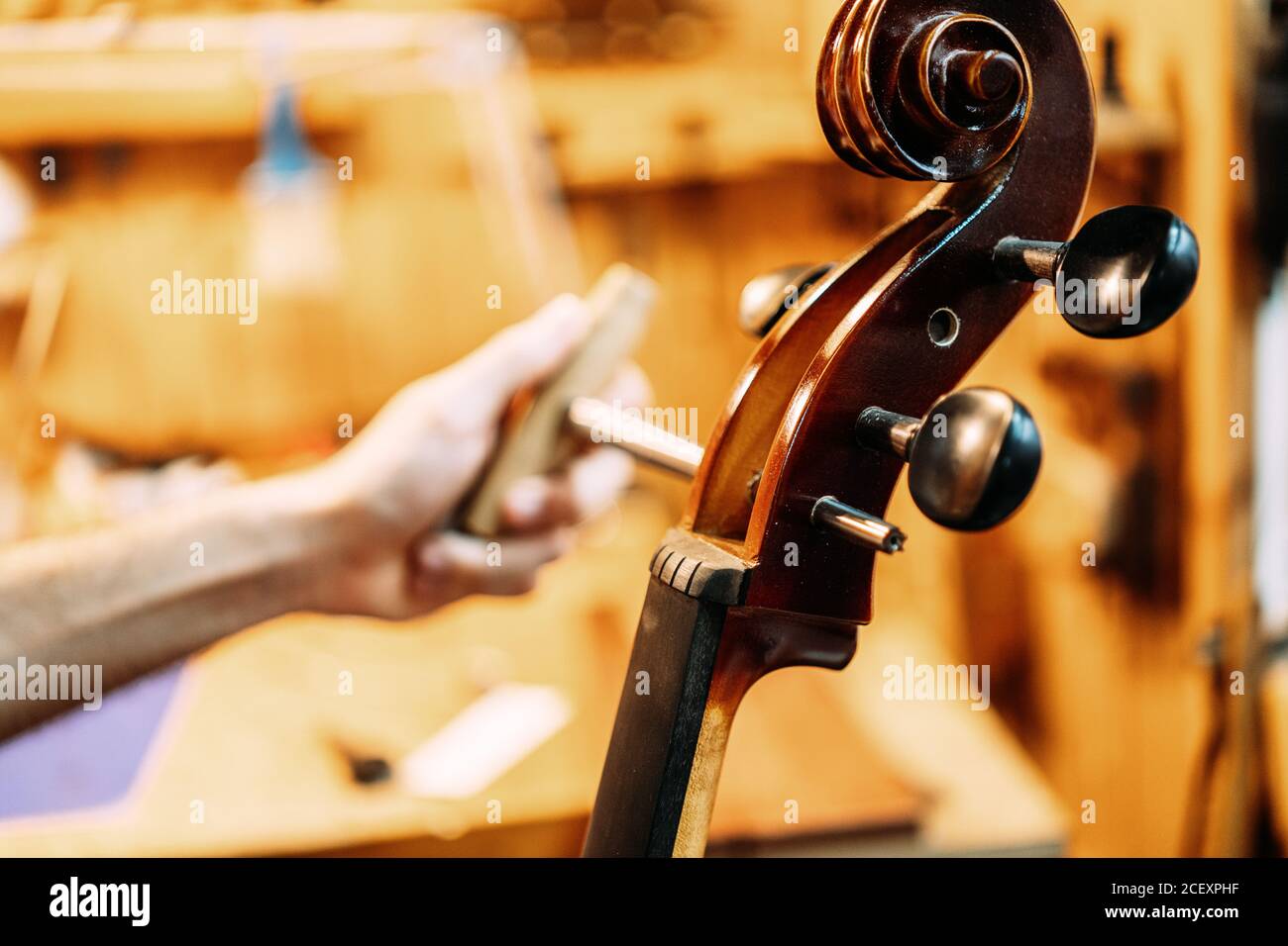 Cropped unrecognizable professional male master using peg hole reamer ...