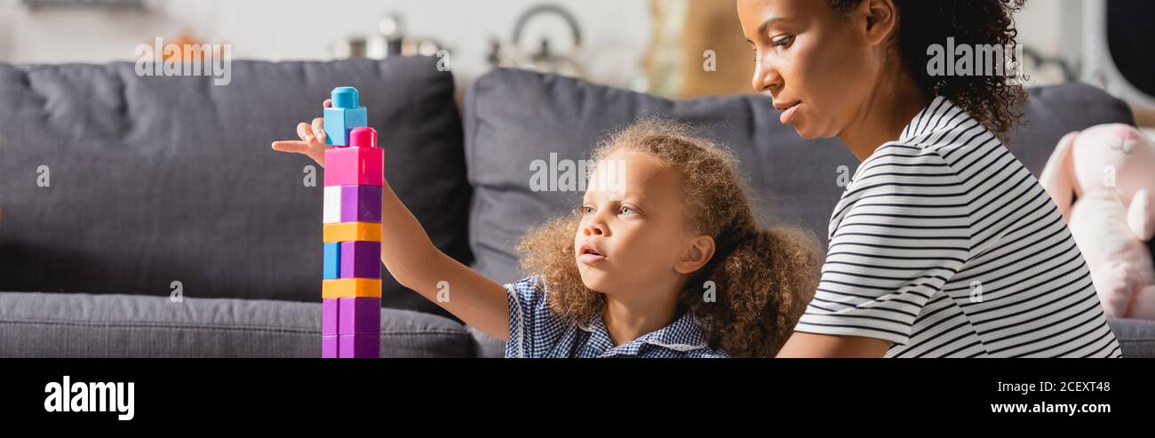 African girl building tower of blocks hi-res stock photography and ...