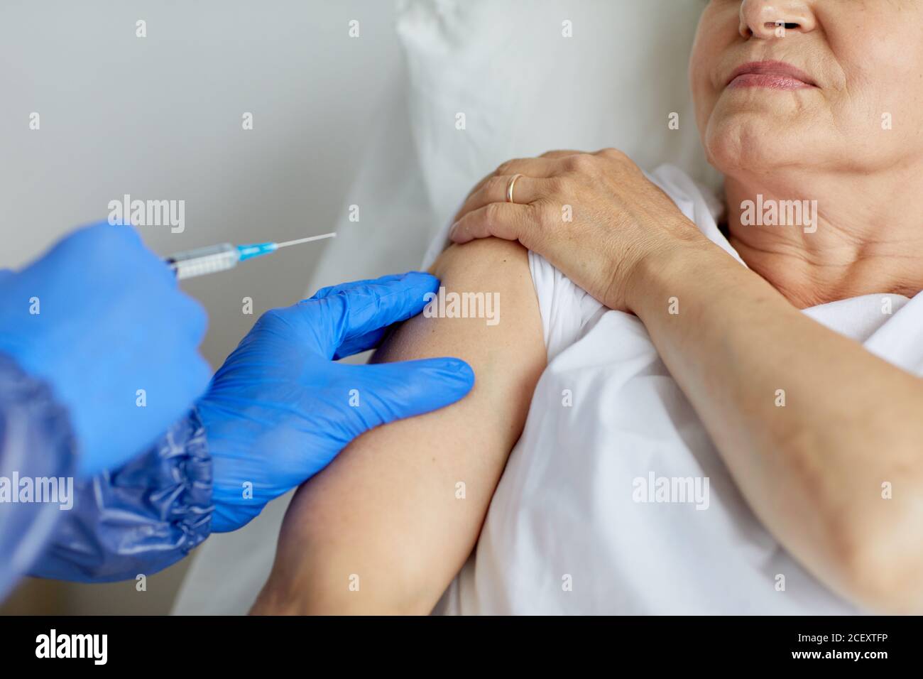 Close-up from above shot of doctor wearing gloves giving antiviral ...