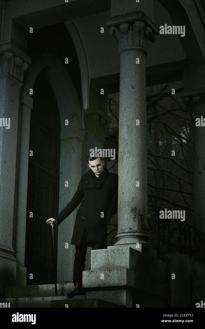 Aristocratic vampire waiting in a stone mausoleum Stock Photo - Alamy