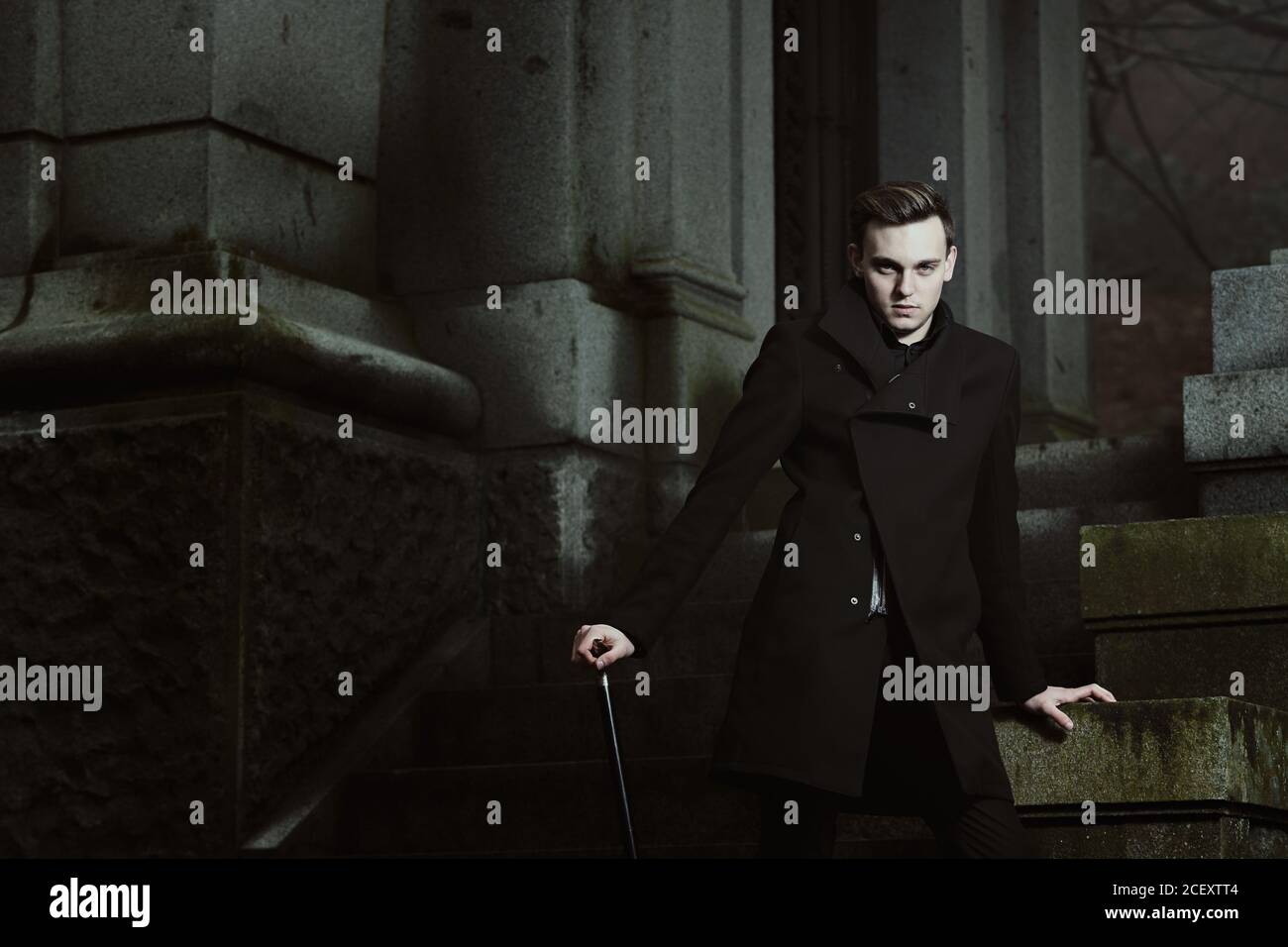 Elegant aristocratic vampire in a stone cemetary Stock Photo - Alamy