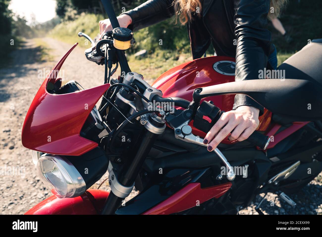 From above low angle of brutal female biker sitting on motorbike on ...