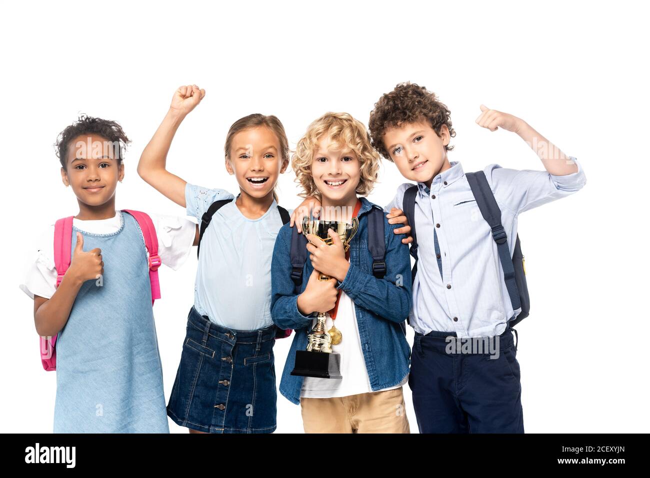 multicultural schoolkids celebrating triumph near curly boy with trophy ...
