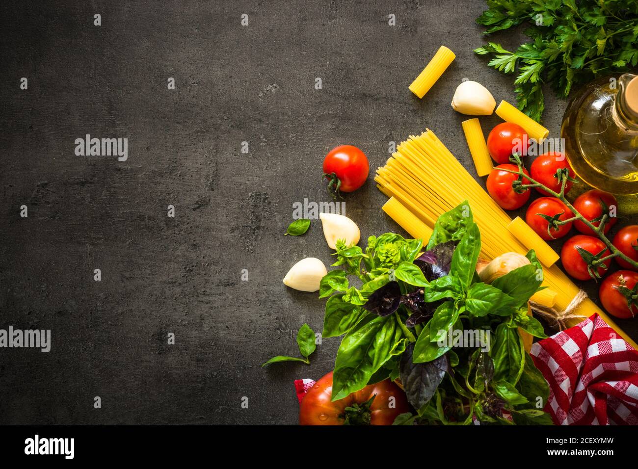 Italian food background on black table Stock Photo - Alamy