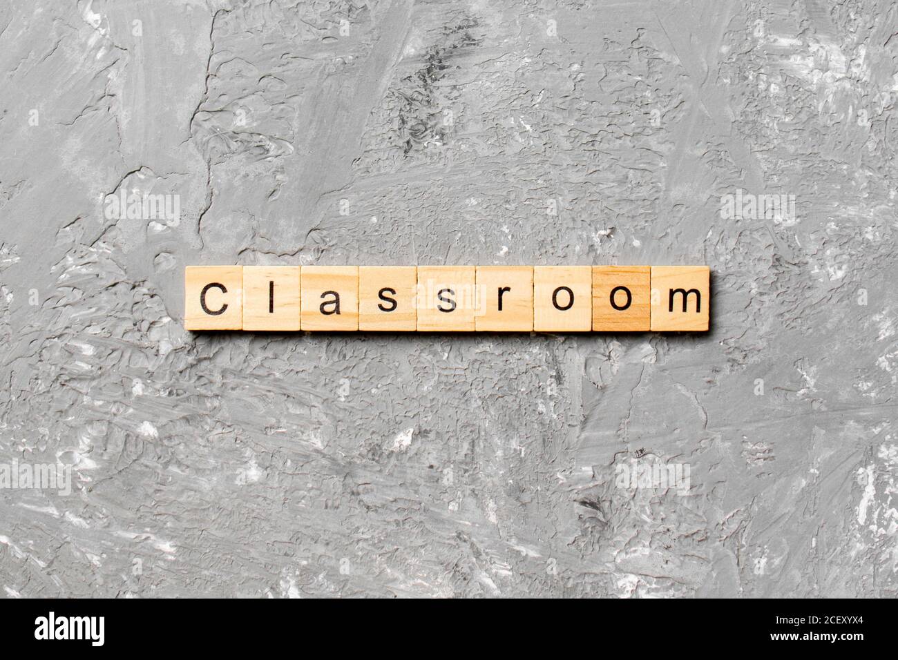 Classroom word written on wood block. Classroom text on cement table ...