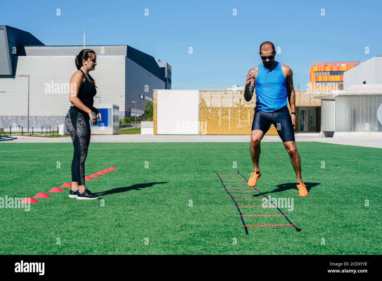Full body of male personal instructor explaining technique of exercise ...