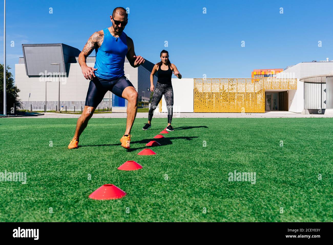 Low angle of determined sportsWoman and sportsman running between ...