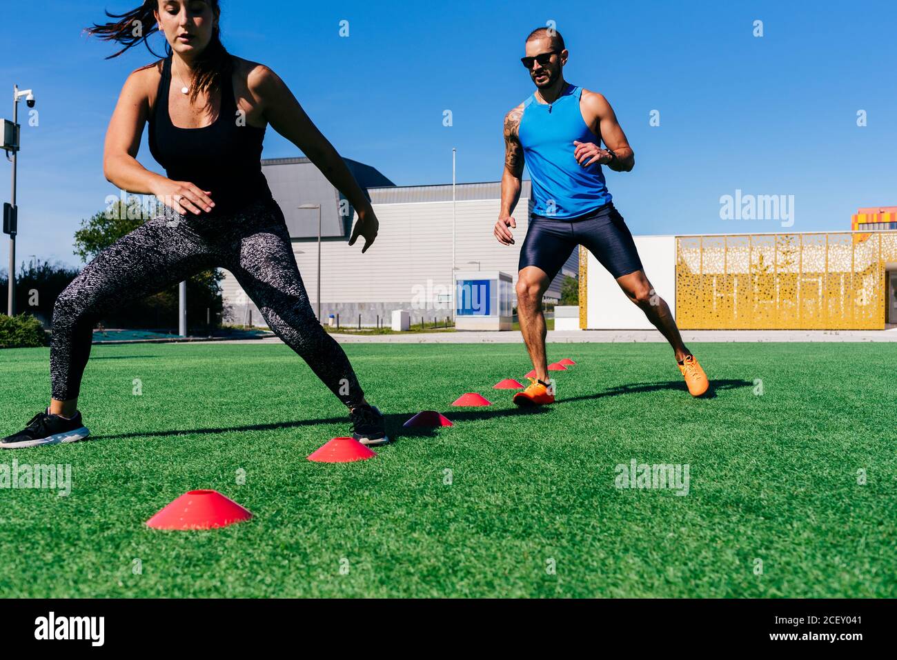 Low angle of determined sportsWoman and sportsman running between ...